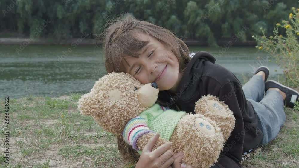 Child with a bear. Happy little girl playing with a teddy bear in ...