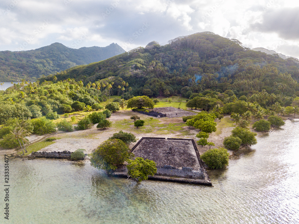Ancient Marae Taputapuatea temple complex on the lagoon shore with ...