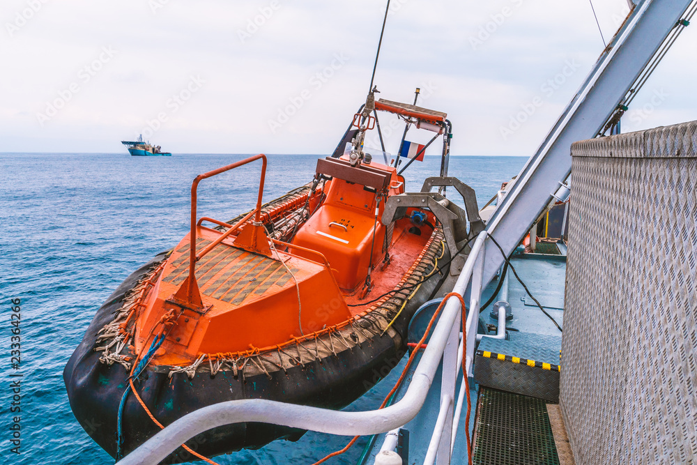 Lifeboat or FRC fast rescue craft boat in the vessel at sea. dsv diving ...