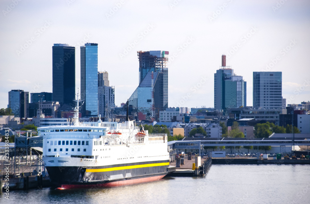 Big ferry in the port on the background of the modern city of Tallinn ...