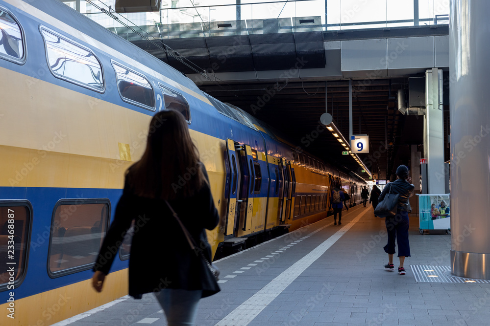 Train platform with an intercity train waiting to transport the people ...