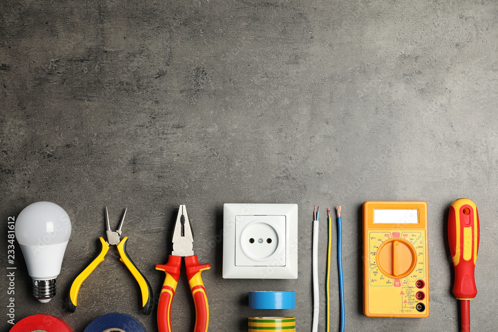 Electrician's tools and space for text on gray background, flat lay ...