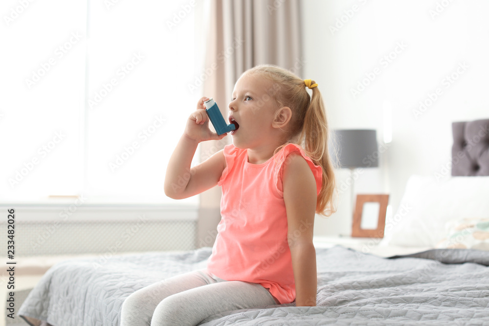 Little girl using asthma inhaler in bedroom Stock Photo | Adobe Stock
