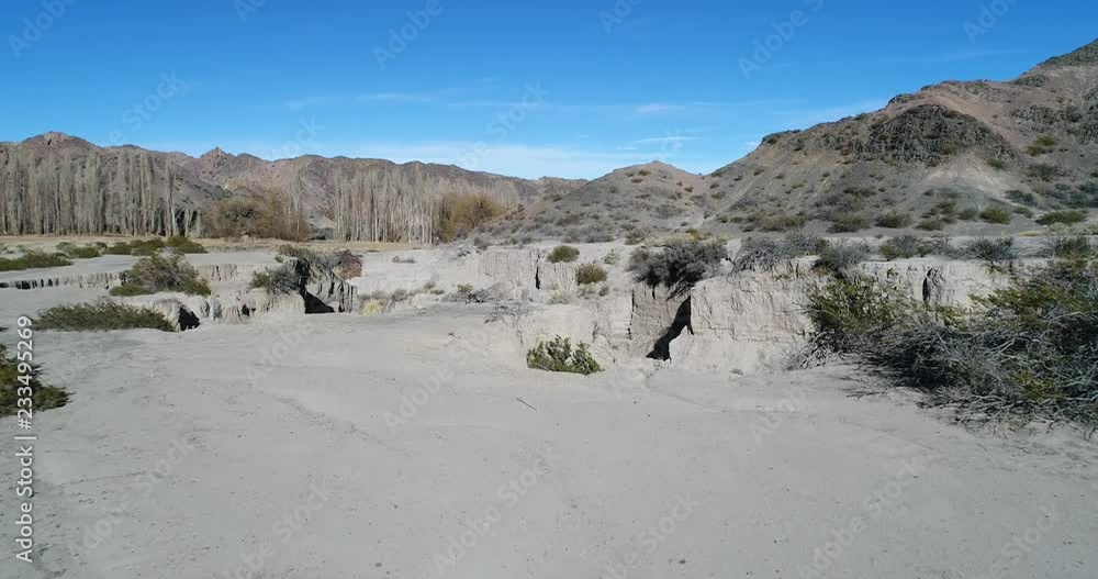 Flying inside ravine of El Leoncito river. Ascending between rocky ...