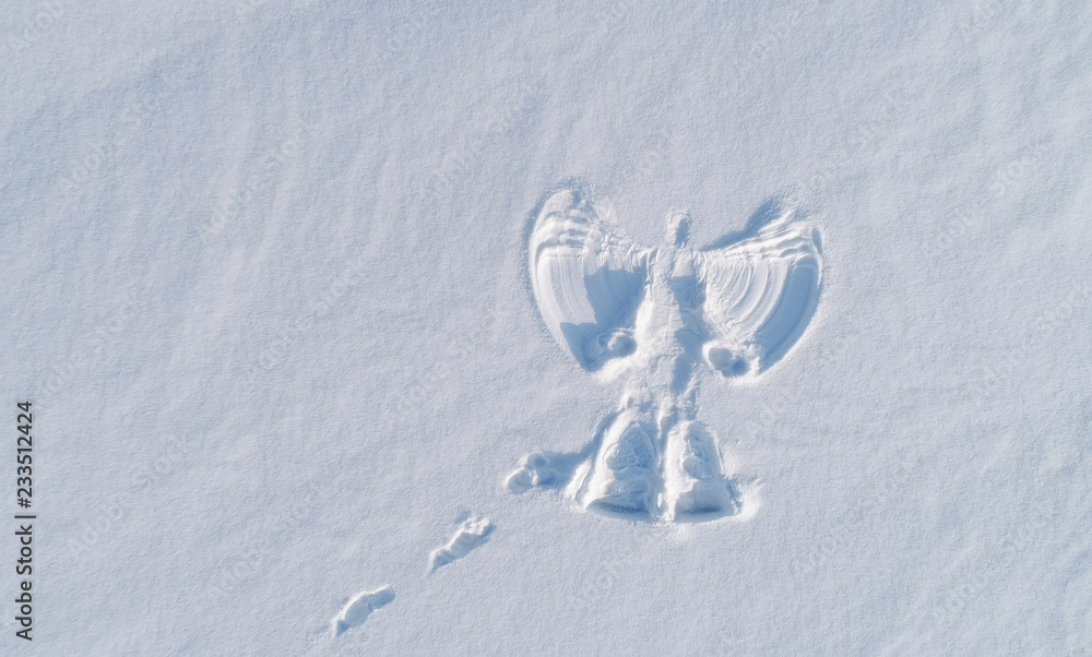 Snow angel's print on a snowcovered area. Aerial foto. Stock Photo ...