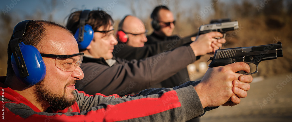 People Shooting Guns At A Range