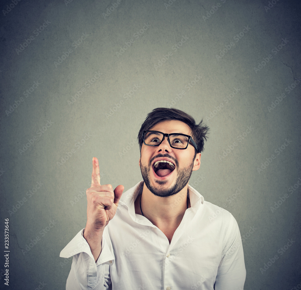 Excited young man pointing up Stock Photo | Adobe Stock