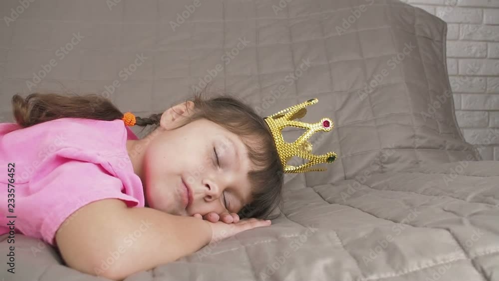 Sleeping princess. Charming little girl sleeping in the crown. Stock ...
