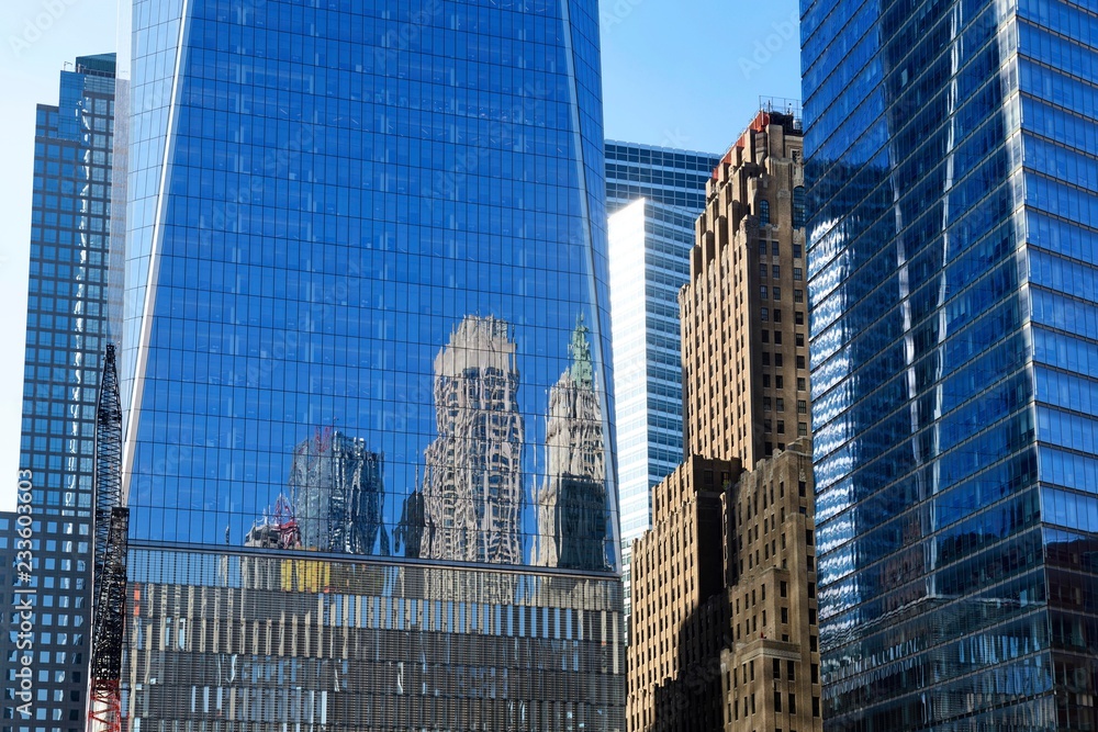 Reflection of the surrounding skyscrapers in the glass facade of the ...