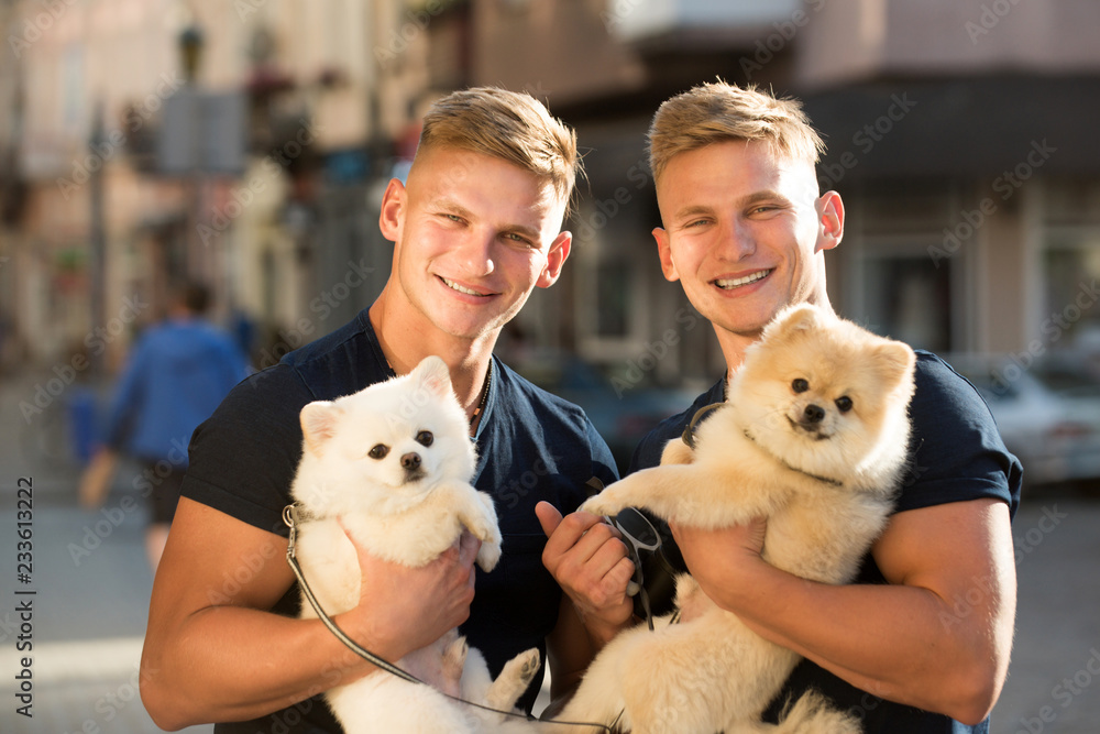 Time for a walk. Muscular men with dog pets. Twins men hold pedigree ...