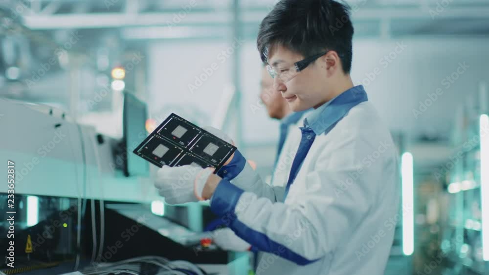 High-Tech Factory: Quality Control Engineer Checks Electronic Printed ...