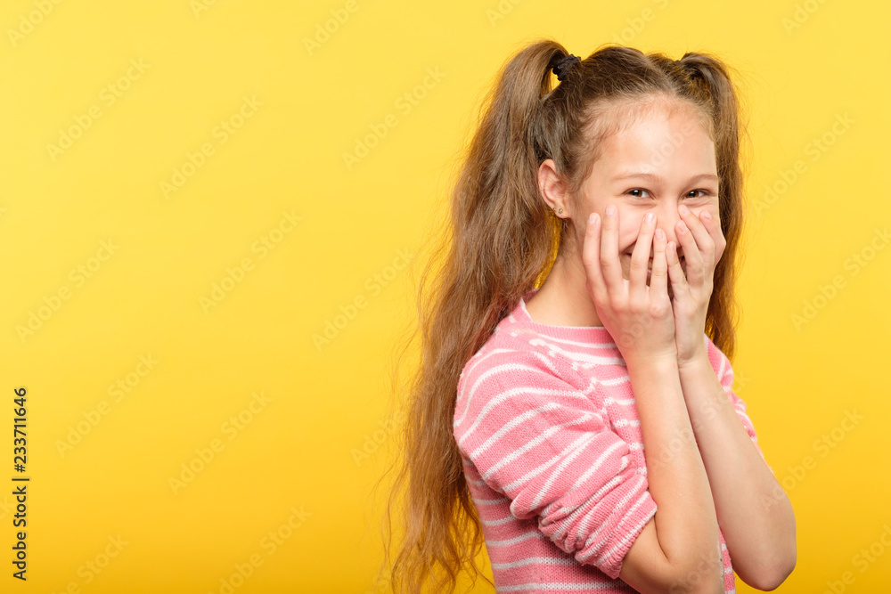 shy smiling embarrassed girl covering mouth with hands. young cute ...