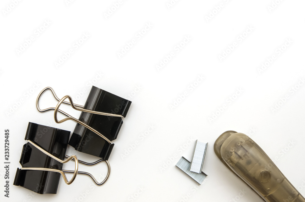 Black clips, clamps, brown stapler and staples as a method of use with ...