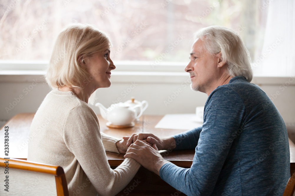 Stockfoto Loving senior couple have romantic moment looking in eyes ...