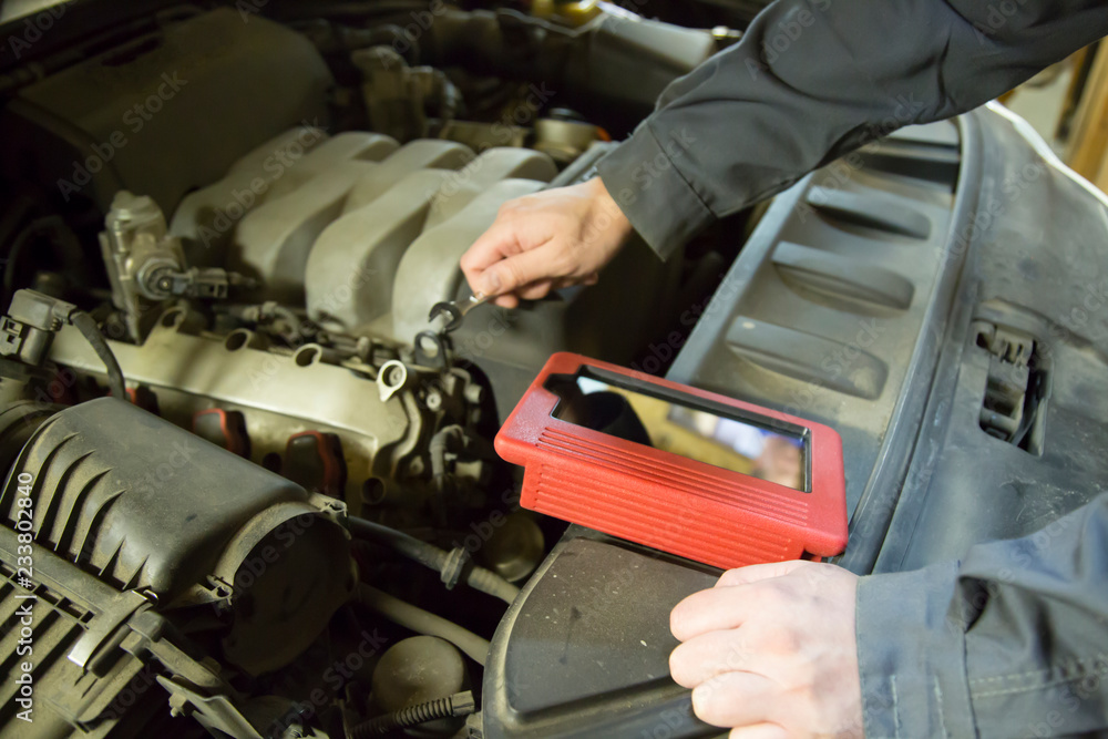 Auto mechanic testing the electrical system on automobile Stock Photo ...