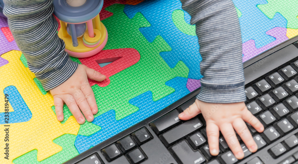 Little hands of a child on a computer keyboard - child development ...