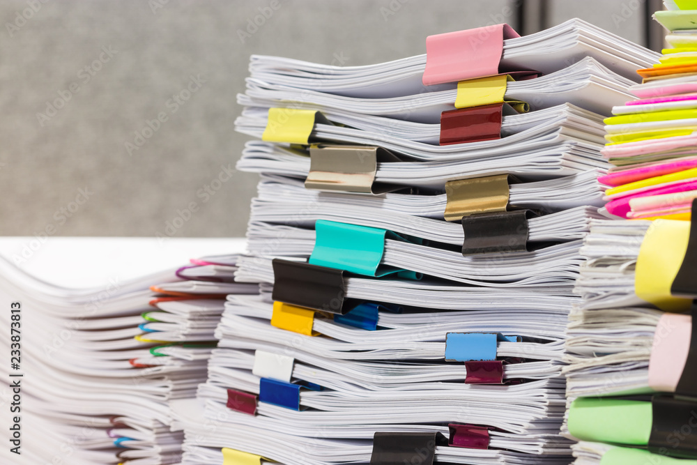Pile of unfinished document on office desk. Stack of homework ...