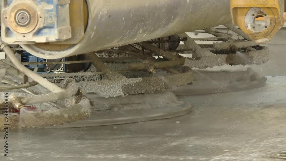 Close of power trowel on fresh concrete. Concrete trowelling machine ...