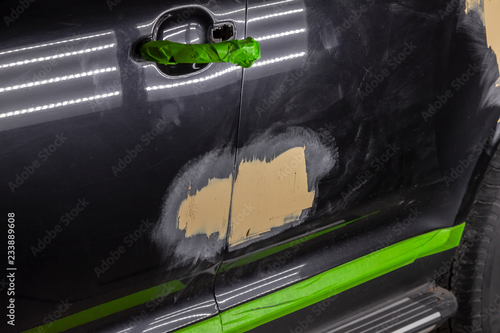 Repair of car body parts in black after an accident and scratches by ...