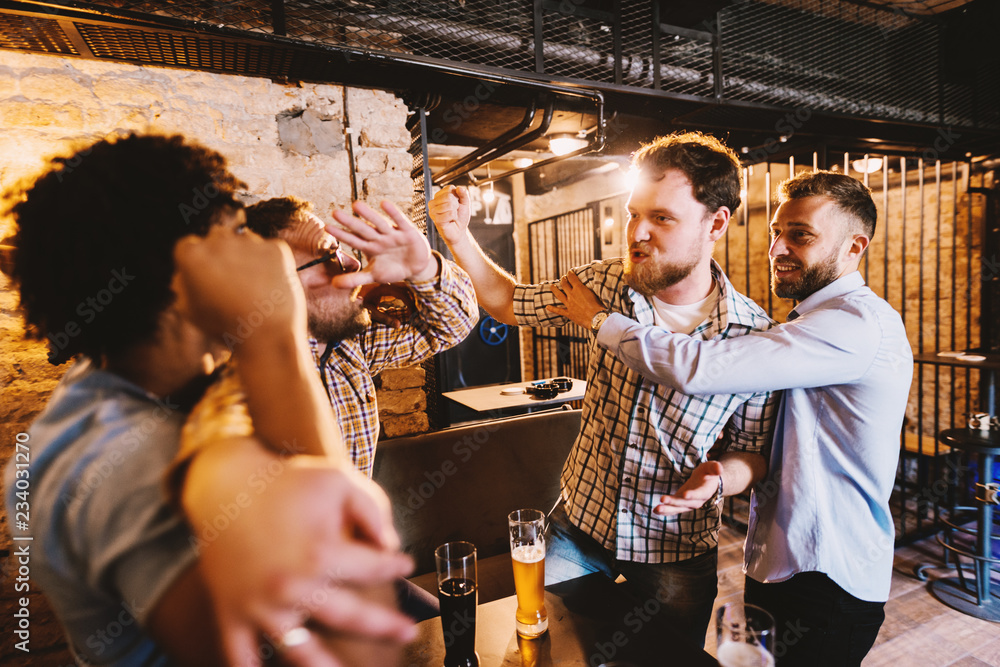 Group of men starting a fight. Stock Photo | Adobe Stock