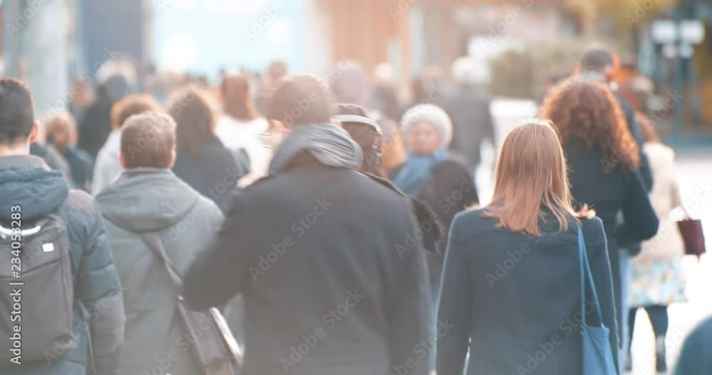 Commuters walking to work with morning sun light in business district ...