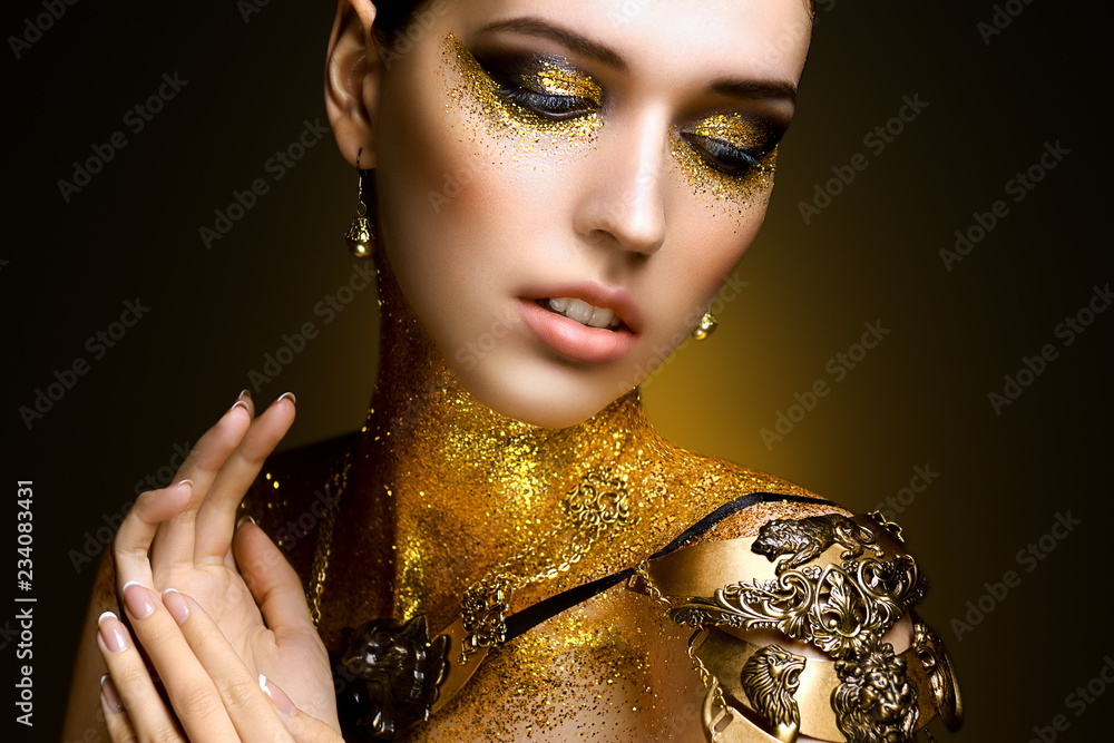 Portrait of beautiful woman with golden glitter on her body. Fashion ...