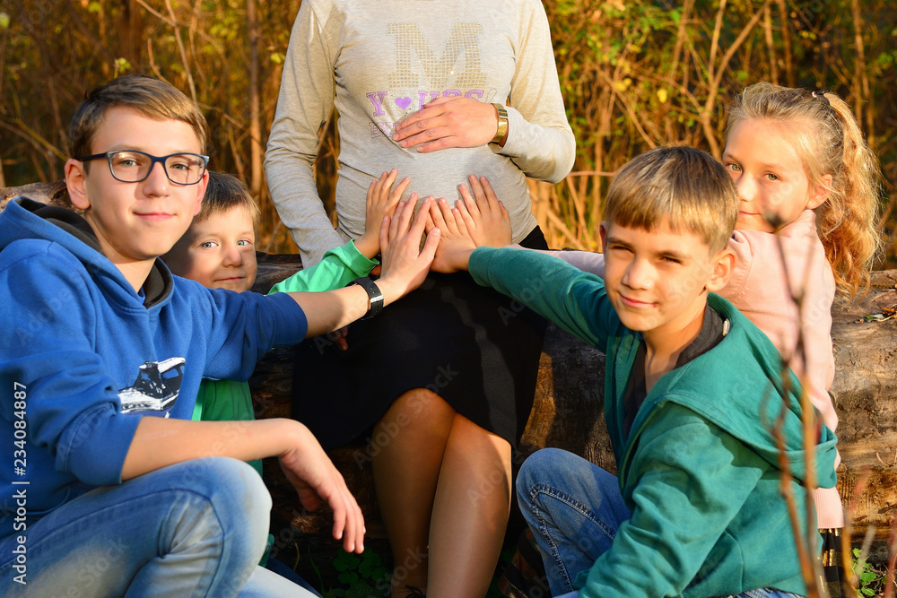 Four children are looking into the camera, small children are sitting ...