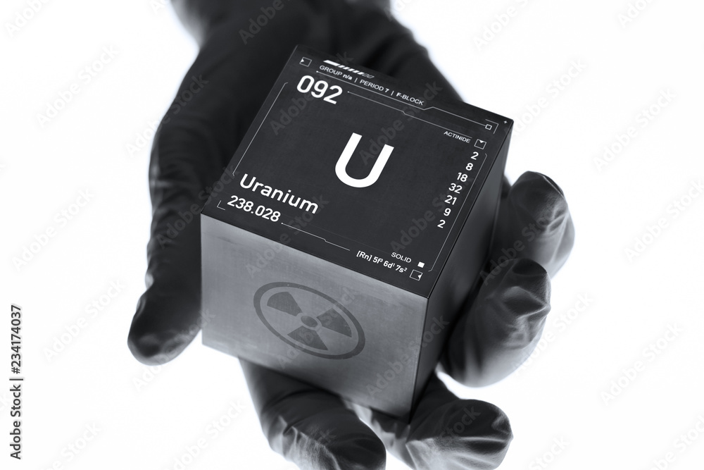 Uranium cube in the hand of a scientist. Radioactive element from the ...
