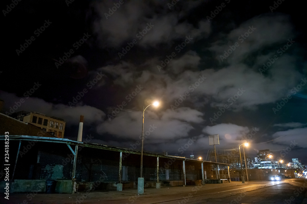 Scary industrial urban street city night scene with train tracks and ...