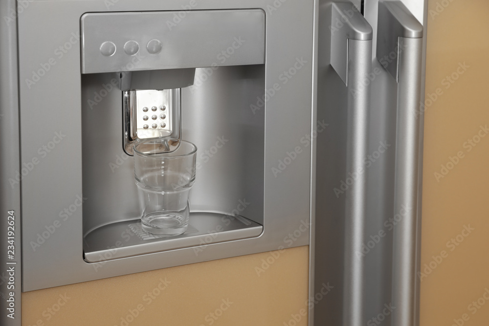 Refrigerator with ice and water system, closeup. Modern kitchen ...