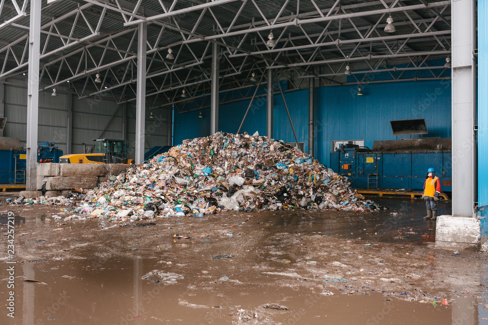 A pile of garbage in a waste storage area at a waste sorting plant ...