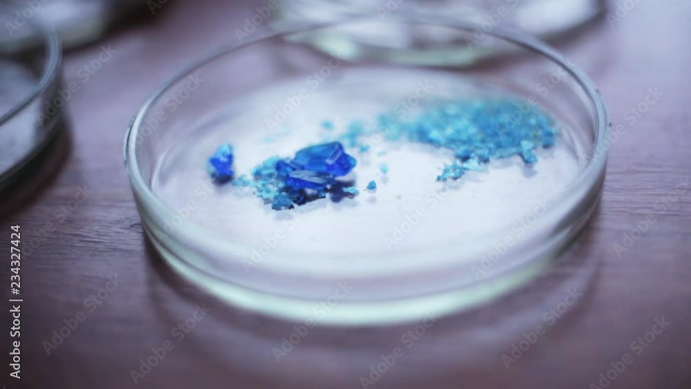 Samples of colored different chemical materials lying on the table in ...