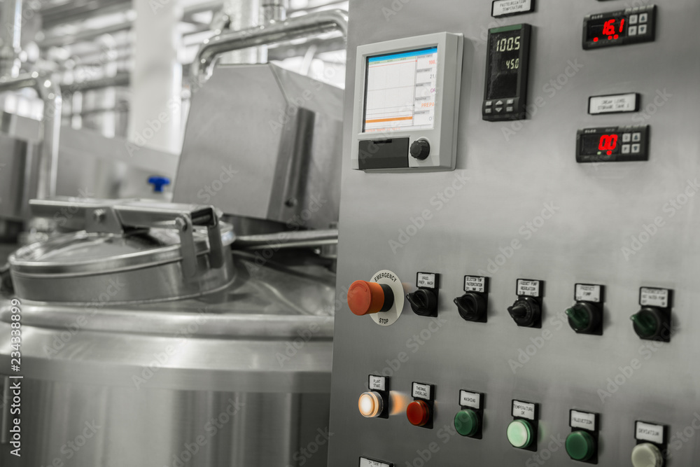 electronic control panel and tank at a milk factory. equipment at the ...