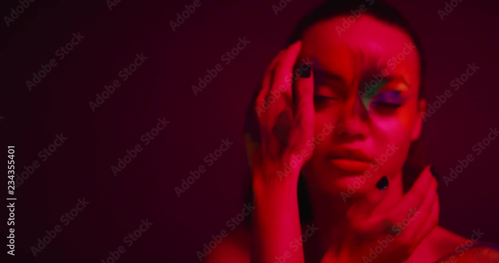 close up colorful portrait attractive woman wearing fluorescent face ...