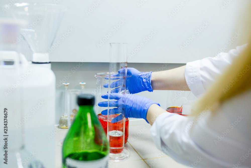 Hands of the scientist in the laboratory mixes with transfusion a ...