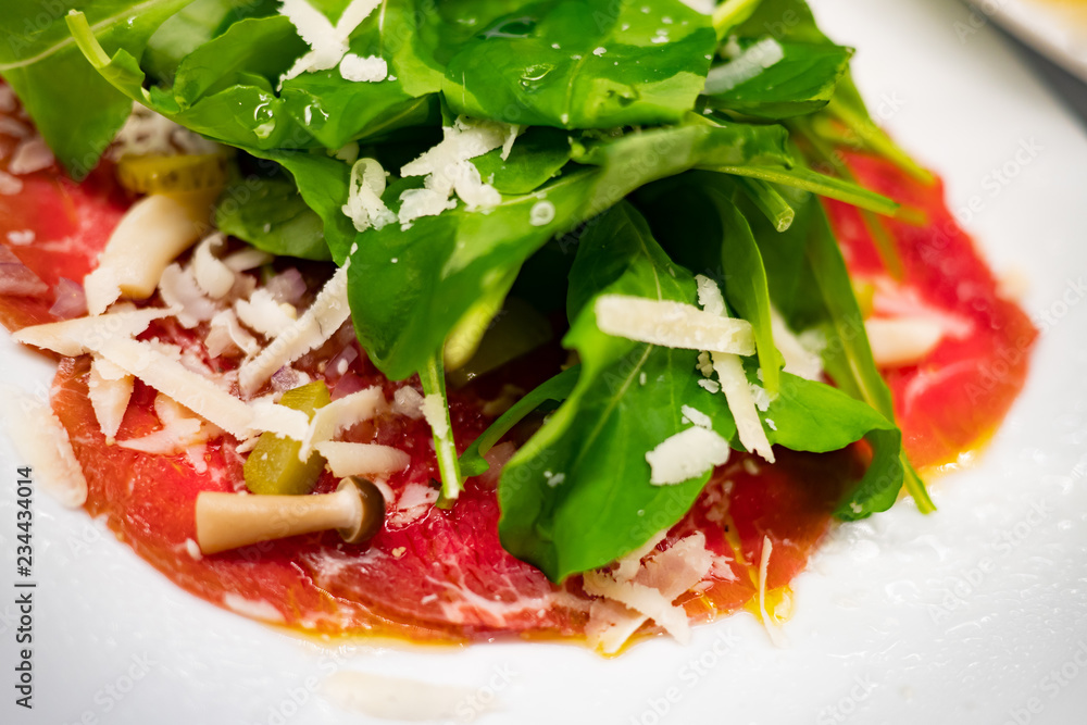 Delicious and healthy Raw Food. Carpaccio di Manzo or Beef carpaccio on ...