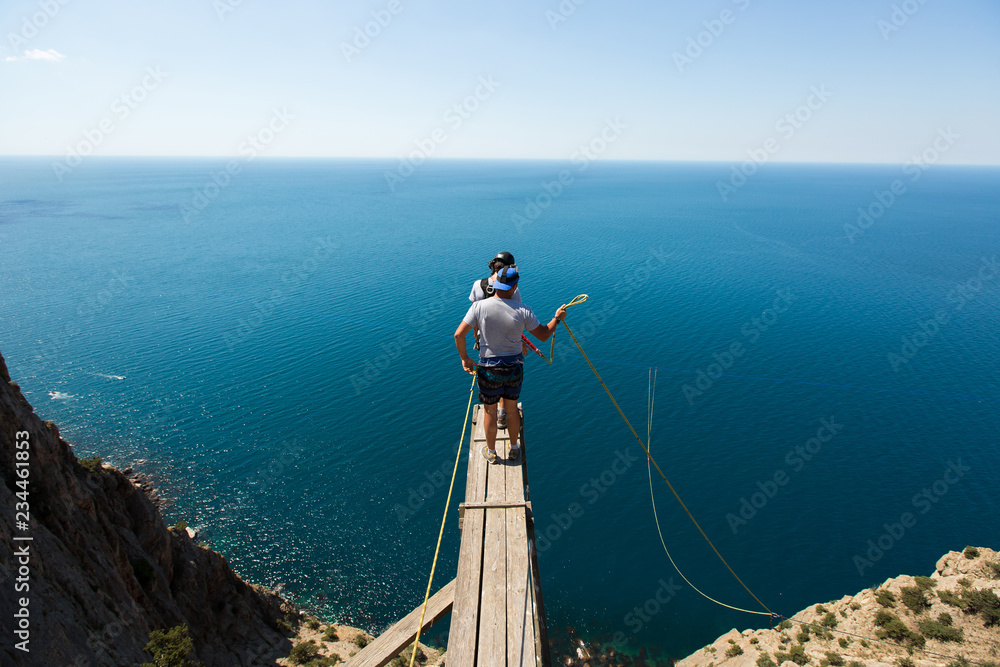 Rope jumping off a cliff with a rope in the water. The ocean. Sea ...
