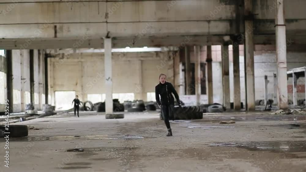 Girl in black leather clothes running away from killer in unfinished ...