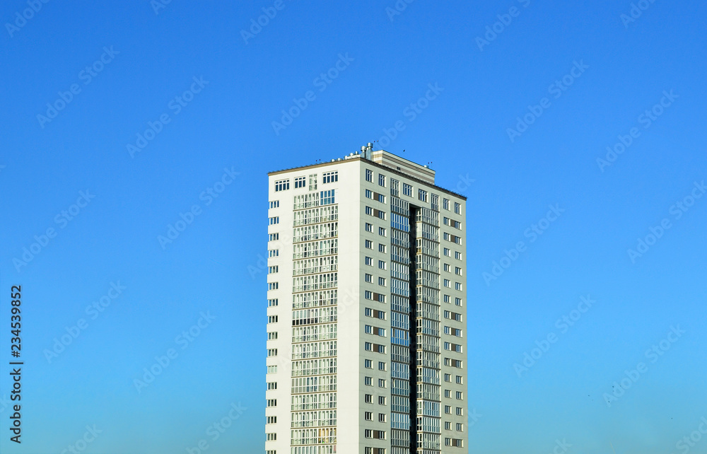 The facade of a high-rise building with windows and balconies ...