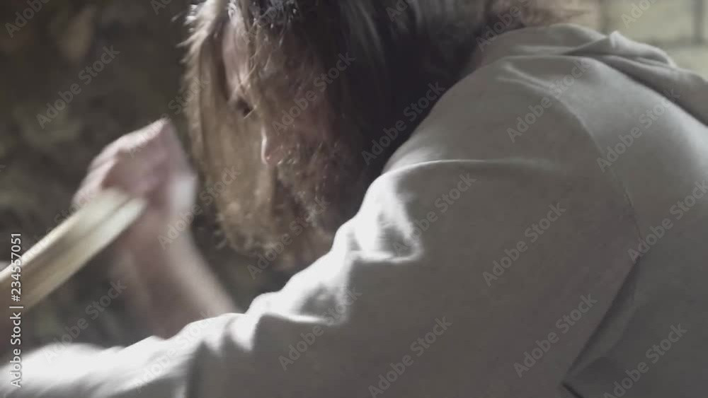 Video „A man like Jesus Christ is digging a hole in the dungeon, a man ...