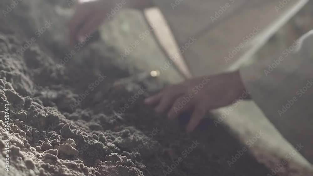 A man like Jesus Christ is digging a hole in the dungeon, a man is ...