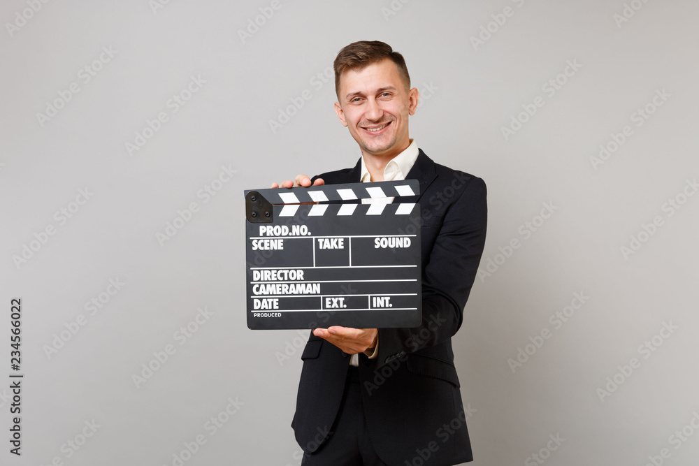 Handsome young business man in classic black suit shirt holding classic ...