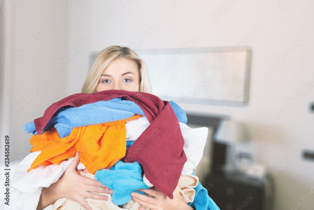 Young Tired Woman Carrying heap of different clothes Stock-Foto | Adobe ...