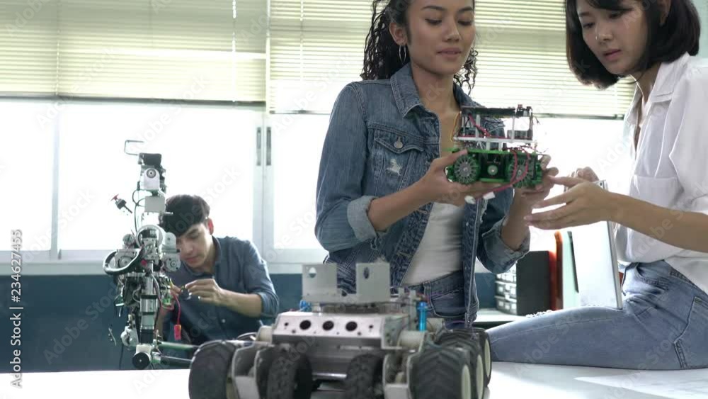Robotics team collaborating development robot in modern laboratory. concept of hardware ...