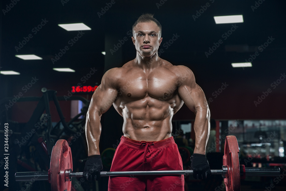 Muscular athletic bodybuilder fitness model posing after exercises in ...