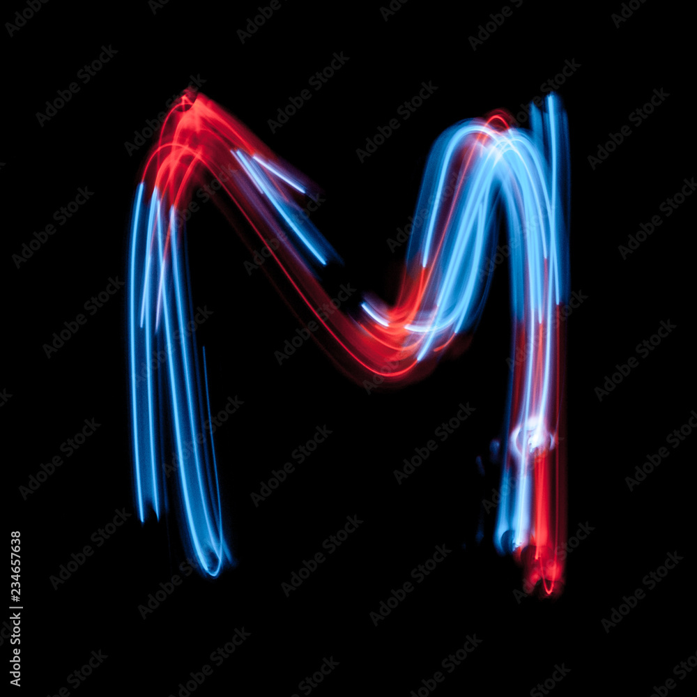 Letter M of the alphabet made from neon sign. The blue light image ...
