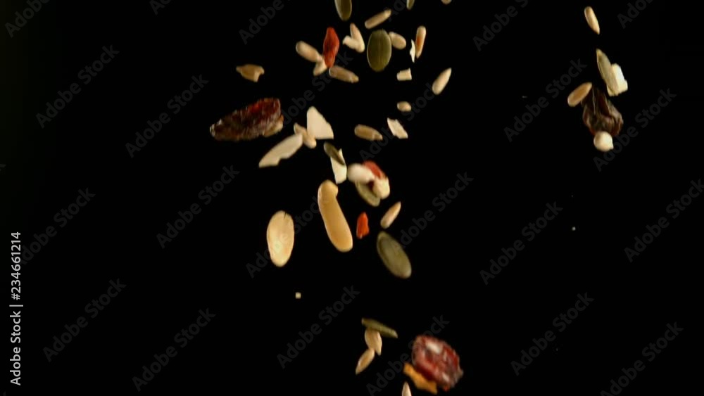 Dry fruits falling against black background 4k Stock 비디오 | Adobe Stock