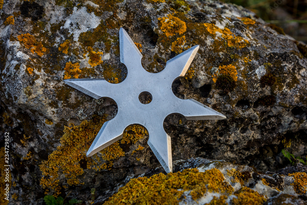 Shuriken (throwing star), traditional japanese ninja cold weapon stuck ...