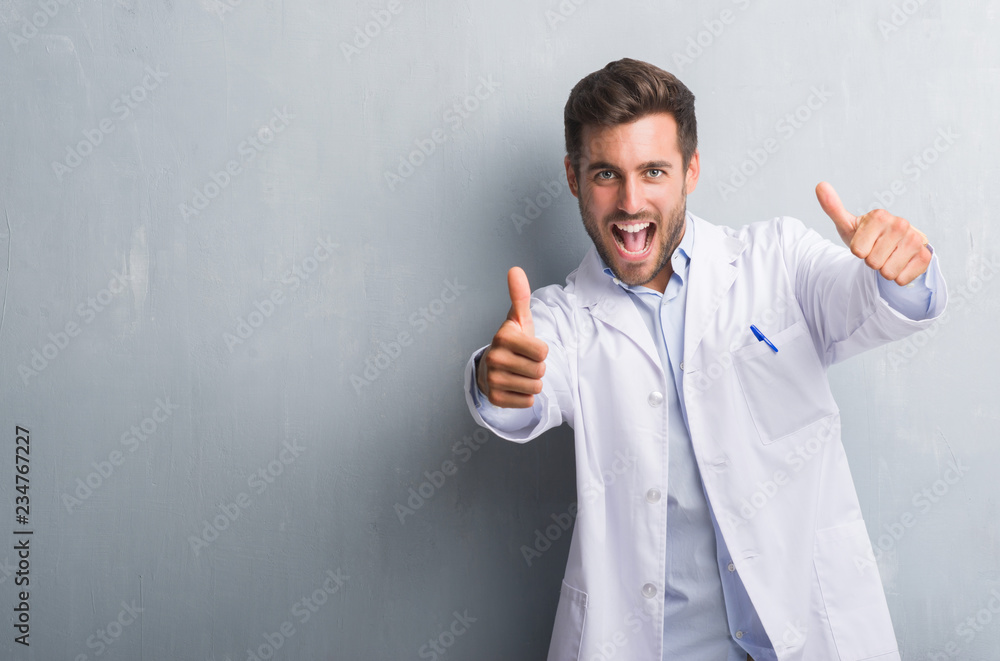 Handsome young professional man over grey grunge wall wearing white ...