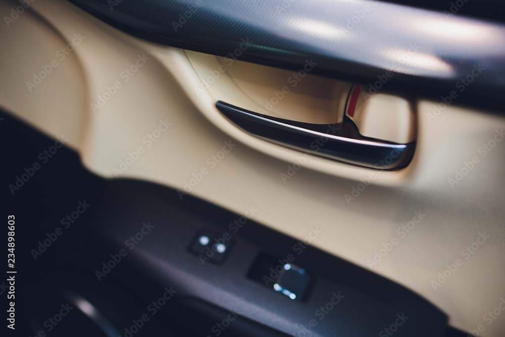 car leather interior details of door handle with windows controls and ...